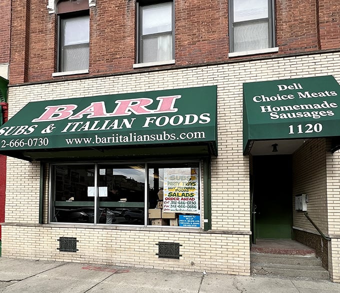 The iconic green awning of Bari Foods stands as a beacon of sandwich salvation on Chicago's Grand Avenue, promising Italian delights within those brick walls.