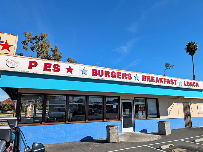 The bright turquoise exterior of Allstar Burger stands out like a beacon of hope for the hungry, complete with red stars promising burger salvation.