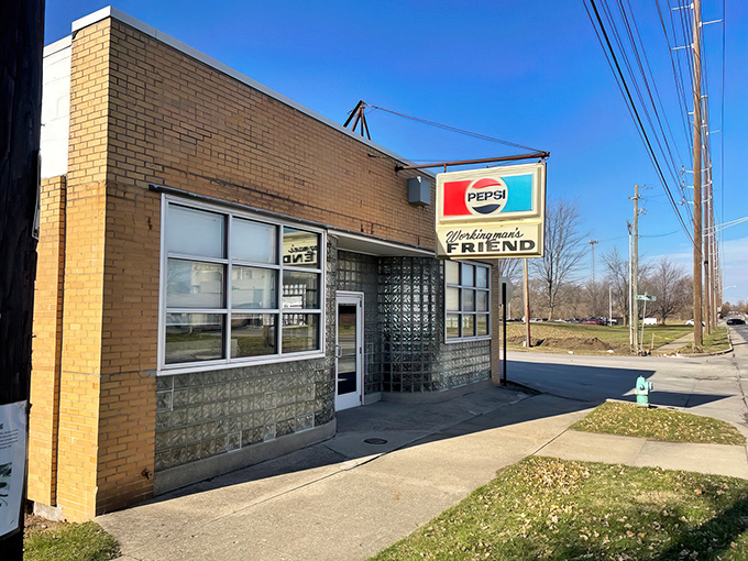 The unassuming exterior of The Workingman's Friend stands like a time capsule on Indy's west side. That vintage Pepsi sign has been guiding hungry patrons to burger bliss for decades.