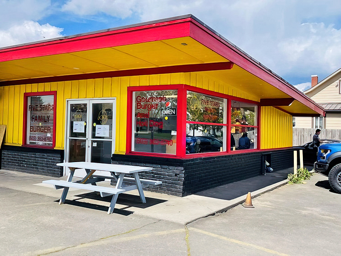 The bright yellow and red exterior of Five Stars Family Burger stands out like a culinary lighthouse in Cornelius, beckoning hungry travelers with its no-frills charm.