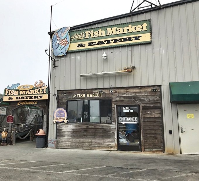 The unassuming exterior of Phil's Fish Market is like finding a treasure chest disguised as a toolshed. Seafood magic happens behind these weathered wooden walls.