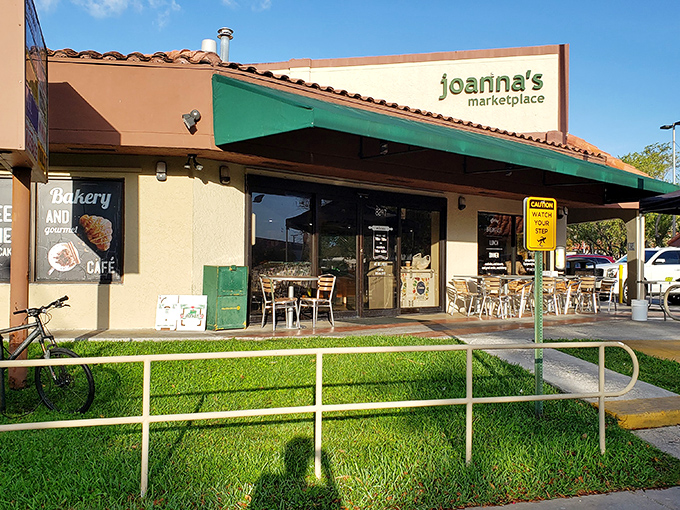 The cheerful yellow exterior of Joanna's Marketplace beckons like a culinary lighthouse, with those colorful chairs practically shouting, "Sit here and eat something wonderful!"
