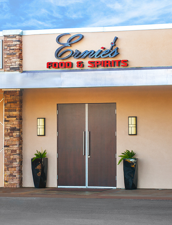 The glowing sign of Ernie's Food & Spirits beckons like a culinary lighthouse, promising delicious refuge from everyday dining disappointments.
