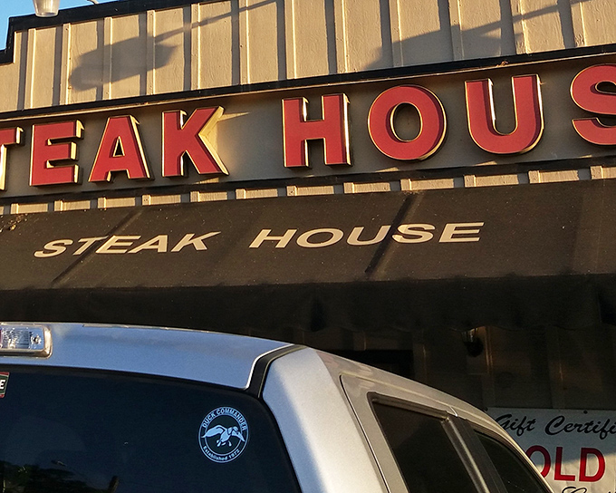 The iconic red lettering of Gus's Steakhouse beckons hungry travelers like a culinary lighthouse in Sonora's Gold Country. A promise of comfort awaits. 