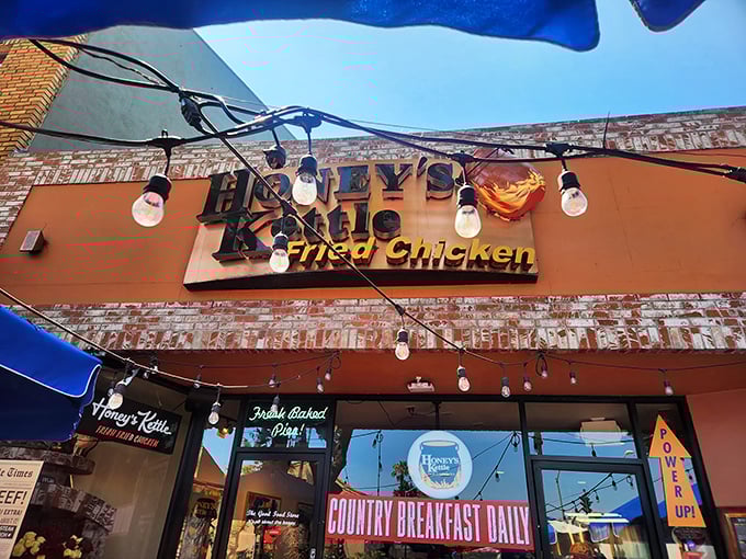 The orange-brick facade and string lights of Honey's Kettle beckon like a siren song for fried chicken aficionados.