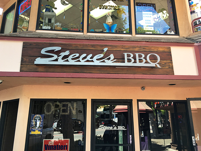 The wooden sign for Steve's BBQ promises simplicity, but inside awaits a complexity of flavors that will redefine your barbecue standards. 
