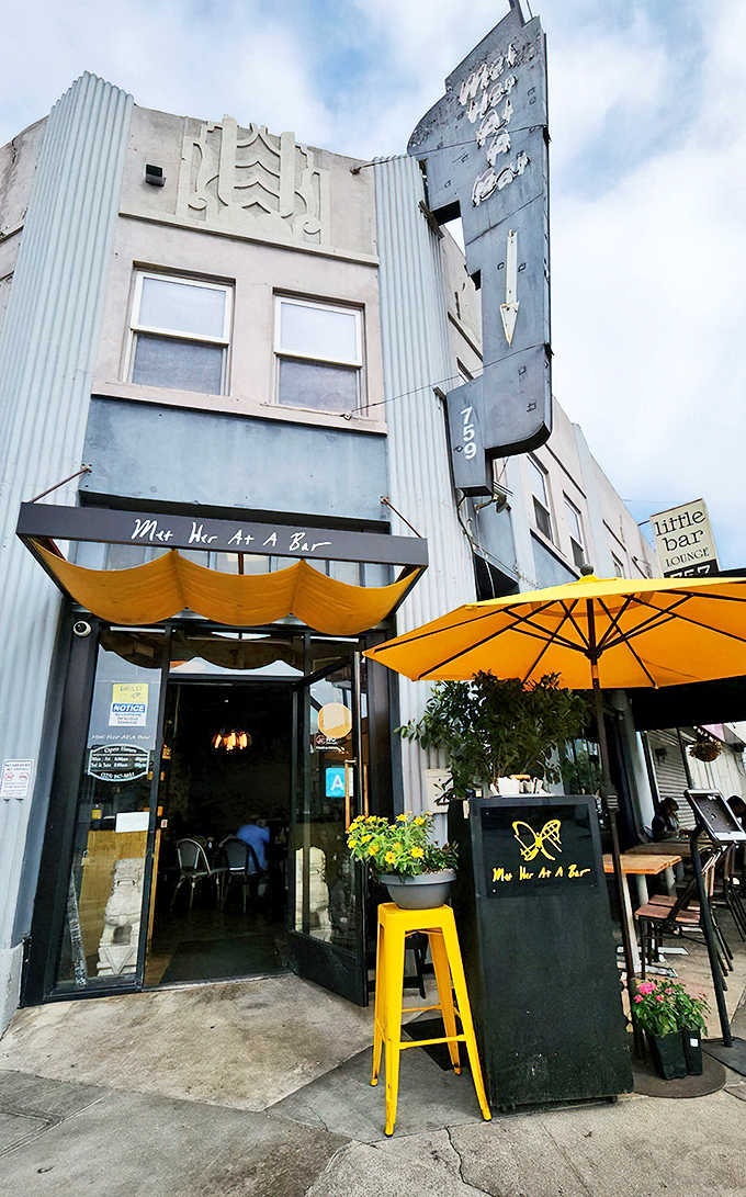 The Art Deco facade of Met Her At A Bar beckons with retro charm and sunny yellow accents, like a time capsule serving modern comfort food.