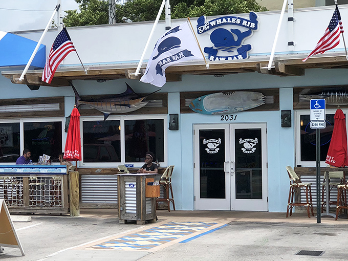 The unassuming blue-and-white exterior of The Whale's Rib stands like a salty sentinel, promising seafood treasures within. No pretense, just promise.
