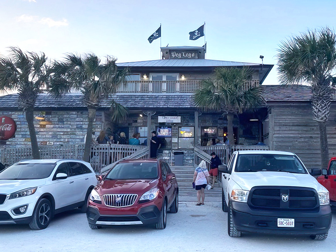 Pirate flags and palm trees welcome seafood seekers to this weathered wooden treasure chest of a restaurant on Pensacola Beach.