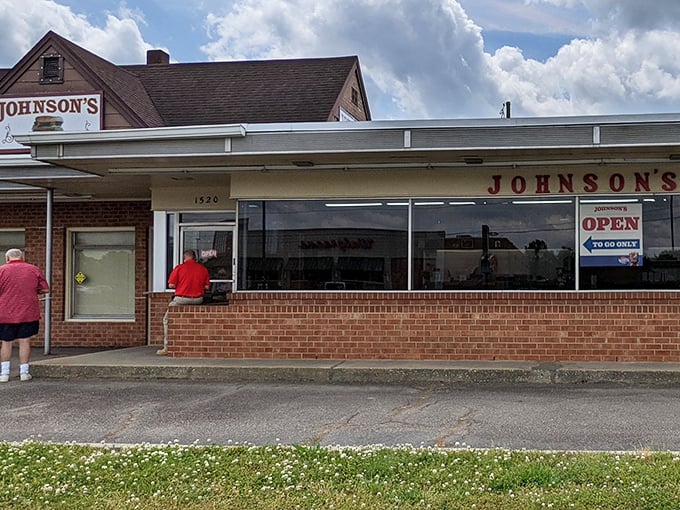 The unassuming brick exterior of Johnson's Drive-In hides culinary greatness like Clark Kent's glasses hide Superman. Worth every minute in line!