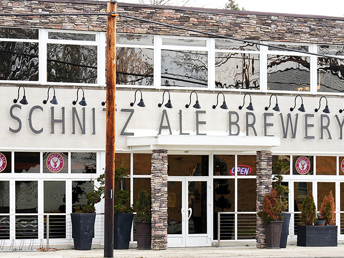 Stone-faced elegance meets German brewing tradition at Schnitz Ale Brewery's exterior. The modern signage promises what awaits inside&mdash;a perfect marriage of craft and comfort.