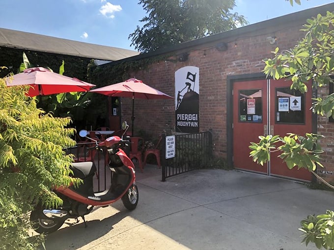The unassuming brick exterior of Pierogi Mountain beckons with its vibrant red umbrellas and casual charm&mdash;proof that culinary treasures often hide in plain sight.