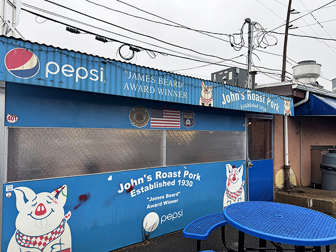 The iconic blue exterior with its cheerful cartoon pig mascot stands as a beacon of sandwich excellence in South Philly. No fancy frills needed.