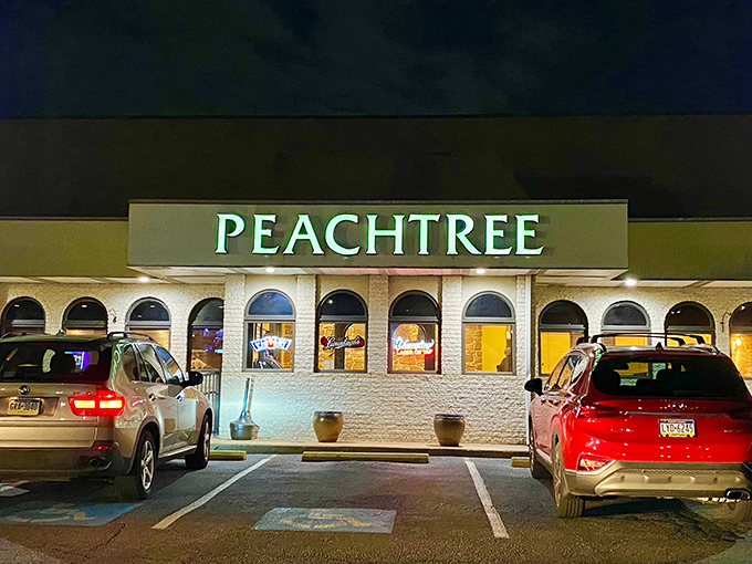 The glowing Peachtree sign beckons hungry travelers like a lighthouse for the gastronomically adrift. No fancy frills, just the promise of serious eating ahead.