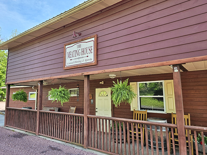 The unassuming burgundy exterior of The Meating House in Drums, PA, where hanging ferns and wooden rocking chairs invite you to "come as you are" for an extraordinary meal.