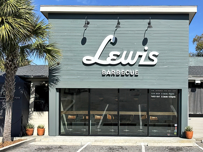 The blue exterior of Lewis Barbecue stands like a smoke-scented beacon in Charleston, with palm trees providing that perfect Southern frame for meat pilgrims.