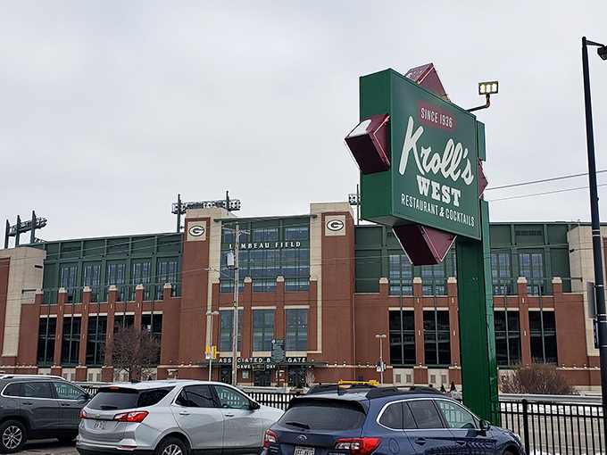 The ultimate Wisconsin power couple: Kroll's West's iconic sign standing proudly across from the cathedral of cheese and football, Lambeau Field.