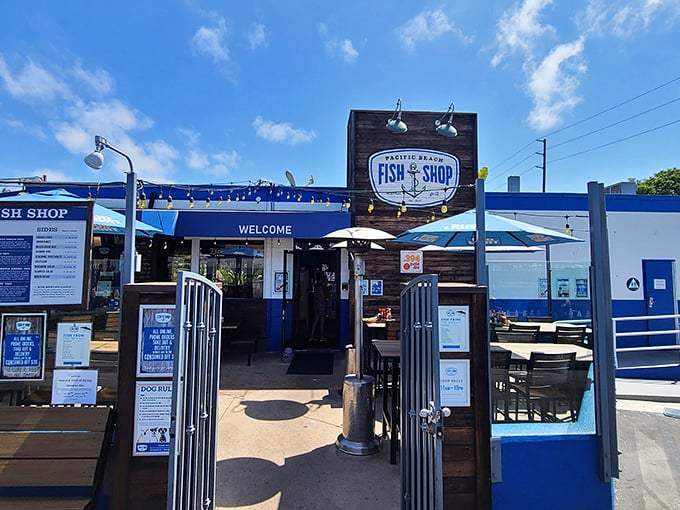 The blue and white exterior beckons like a maritime mirage, promising seafood treasures behind that wooden sign and welcoming gate.