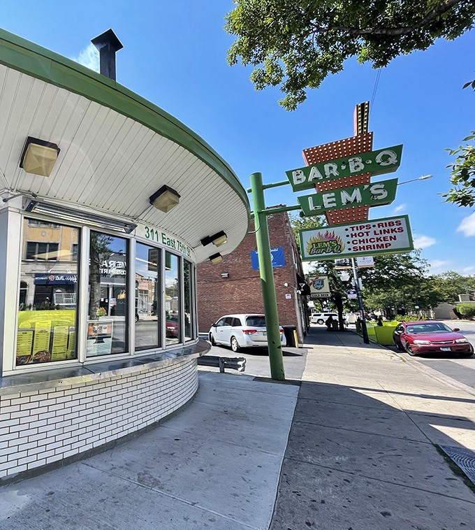 The iconic curved facade and vintage neon sign of Lem's Bar-B-Q stand as a beacon of smoky promise on Chicago's South Side.
