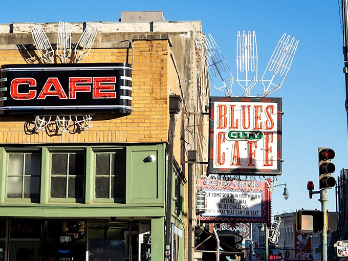 The iconic neon "CAFE" sign beckons hungry travelers like a culinary lighthouse on Beale Street's musical shore.