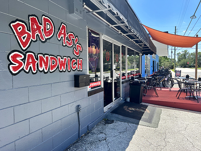 The bold red lettering against gray cinderblock says it all – this place isn't trying to impress you with fancy decor, just life-changing sandwiches.