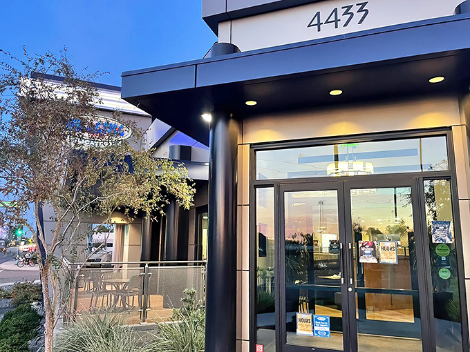 The unassuming exterior of Miracle Mile Deli belies the sandwich paradise within. Like finding a hidden treasure map, that blue sign promises delicious adventures ahead.