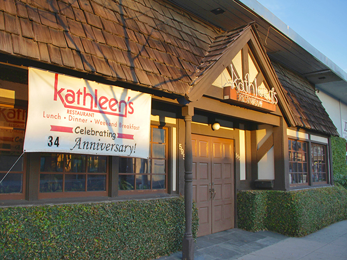The cedar-shingled charm of Kathleen's exterior feels like a warm hug in restaurant form, promising comfort food treasures within those wooden doors.