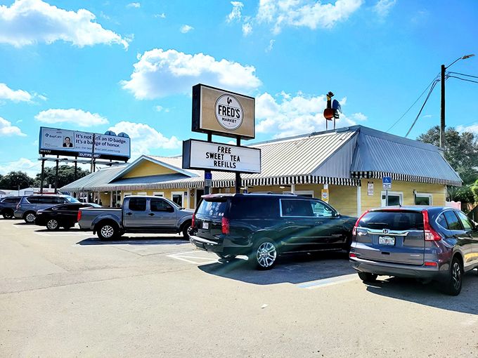Fred's sunny yellow exterior promises comfort before you even walk in. That "FREE SWEET TEA REFILLS" sign isn't just advertising&mdash;it's a love letter to the South.