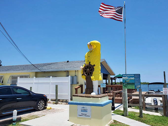 The cheerful yellow fisherman statue stands guard like a maritime sentinel, promising seafood treasures within this unassuming waterfront gem.