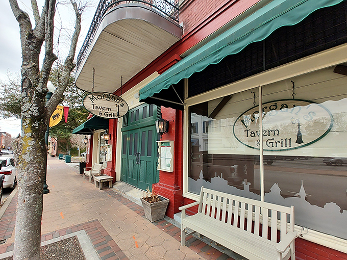 The charming red brick exterior of Morgan's Tavern & Grill beckons from Middle Street, promising comfort and hospitality behind those green doors.