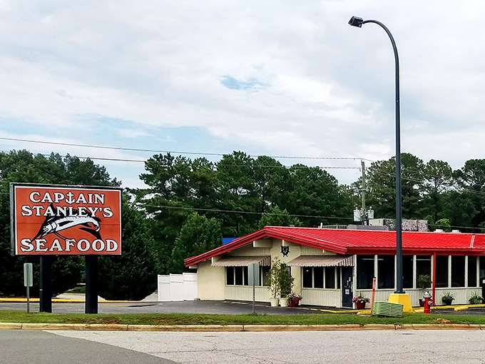 The iconic red roof and bold signage of Captain Stanley's stands as a beacon to seafood lovers, promising no-frills deliciousness inside.