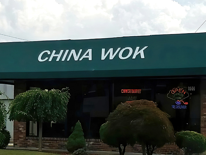 The iconic green awning of China Wok beckons hungry travelers like a culinary lighthouse on East Sullivan Street. No frills, just delicious promises. 