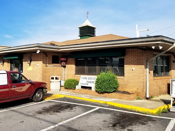 The green-paneled facade with simple white script might not scream "culinary destination," but locals know better. This unassuming entrance hides delicious treasures within.
