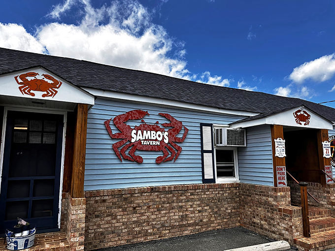 The blue clapboard exterior with giant red crabs isn't subtle advertising&mdash;it's a promise of what awaits inside this Delaware seafood sanctuary.