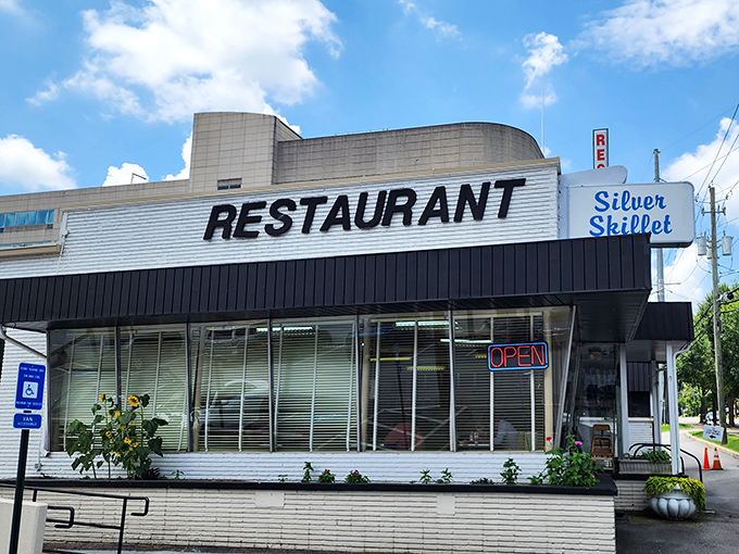 The unmistakable mid-century charm of Silver Skillet's exterior stands as a time capsule in Atlanta's ever-changing landscape. That neon "OPEN" sign has been beckoning hungry patrons for generations.
