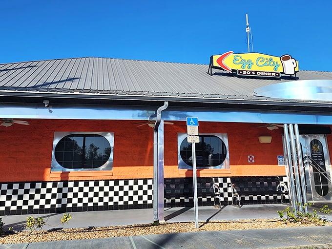The vibrant orange exterior with classic black-and-white checkerboard trim isn't just eye-catching&mdash;it's practically sending breakfast smoke signals to hungry travelers on the highway.
