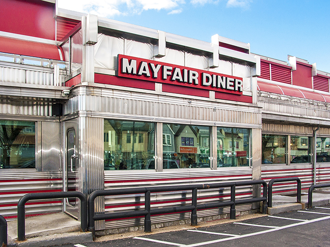 The gleaming stainless steel exterior of Mayfair Diner stands as a shiny time capsule on Frankford Avenue, beckoning hungry Philadelphians with its iconic red signage.