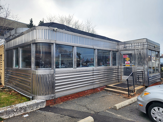 The gleaming stainless steel exterior of Frost Diner stands like a time capsule on wheels, permanently parked in the heart of Warrenton, Virginia.