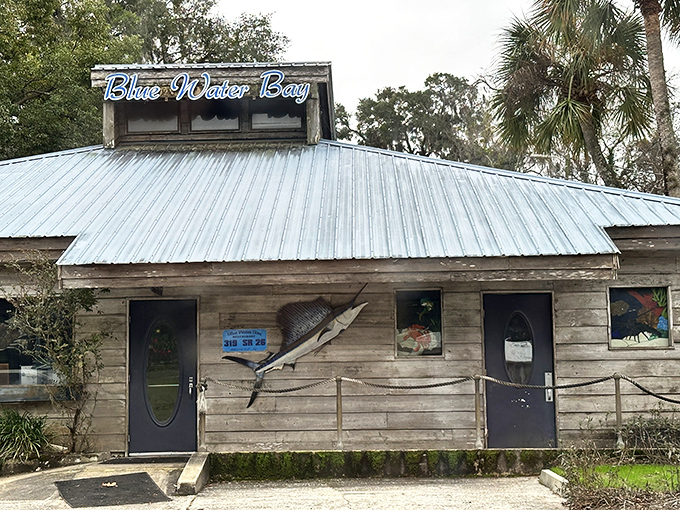 The weathered wooden exterior of Blue Water Bay screams "authentic Florida seafood" louder than a pelican diving for dinner. Pure coastal charm!