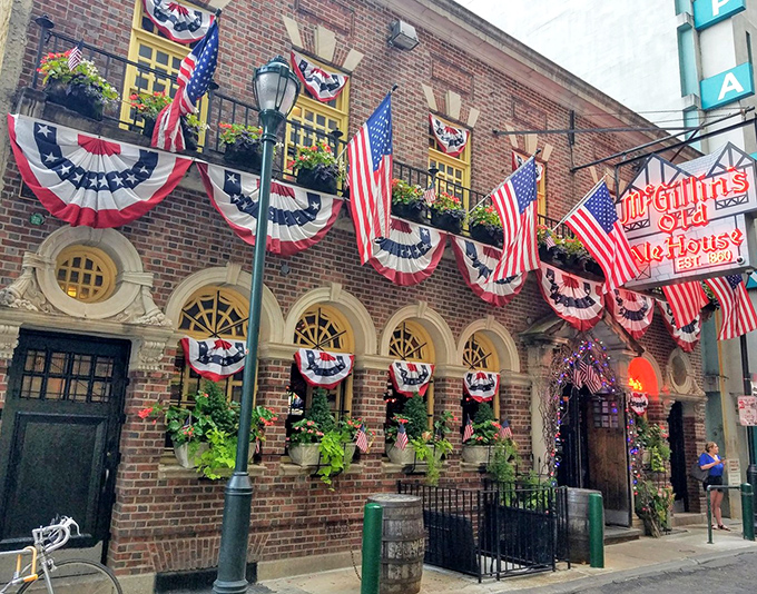 The patriotic facade of McGillin's Olde Ale House stands as Philadelphia's liquid history museum, where every brick has a story and every flag welcomes you home.