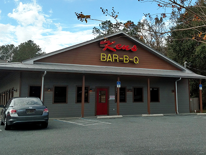 The red neon sign beckons like a lighthouse for hungry travelers. Ken's unassuming exterior promises what truly matters in barbecue: substance over style.