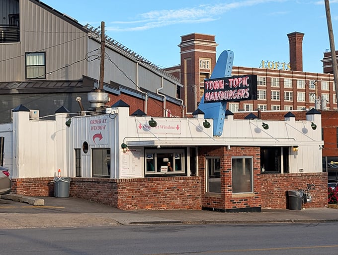 The iconic Town Topic sign stands proud against the Missouri sky, a beacon of burger perfection since 1937 that's outlasted countless food trends.