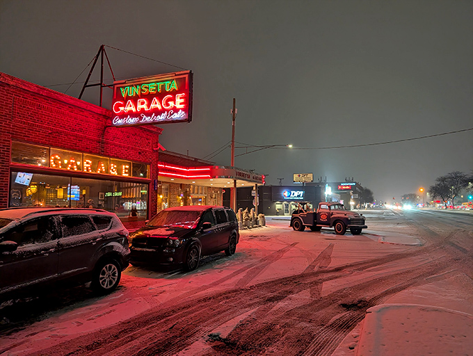 That neon glow against fresh snow isn't just a sign&mdash;it's a beacon calling hungry travelers home. Woodward Avenue's automotive shrine transforms into a culinary sanctuary after dark.