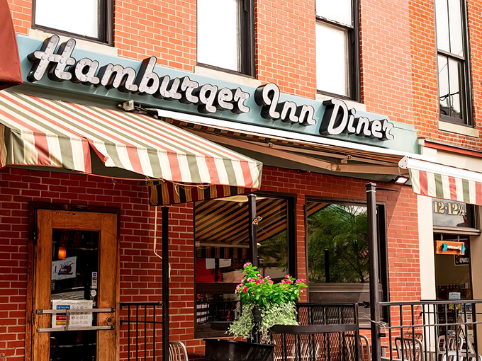 The iconic blue signage of Hamburger Inn Diner beckons hungry travelers like a neon lighthouse on Delaware's main street, promising comfort food salvation inside.