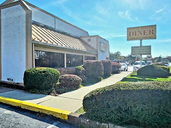 The classic white exterior with its striped awning and "OPEN 24 HOURS" sign stands as a beacon of hope for hungry travelers at any hour.
