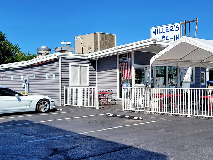The unassuming blue-gray exterior of Miller's Drive-In stands as a time capsule of Americana, where culinary memories are made one scoop at a time. 