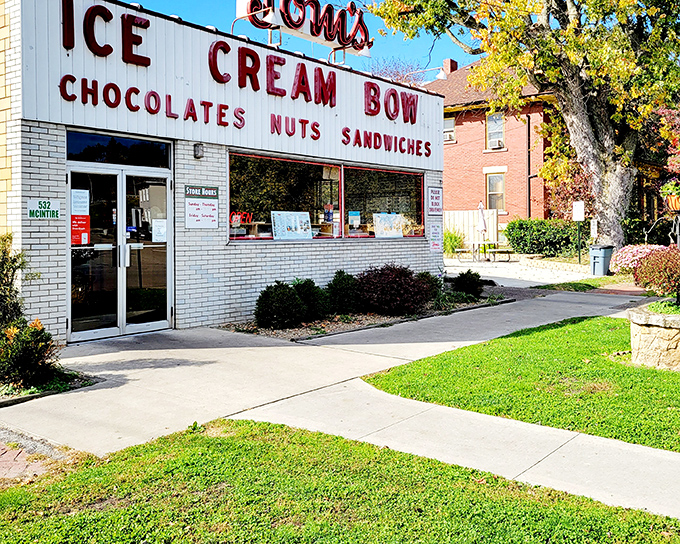 The classic white brick fa&ccedil;ade of Tom's Ice Cream Bowl stands as a time capsule of Americana, promising sweet memories and even sweeter treats inside.