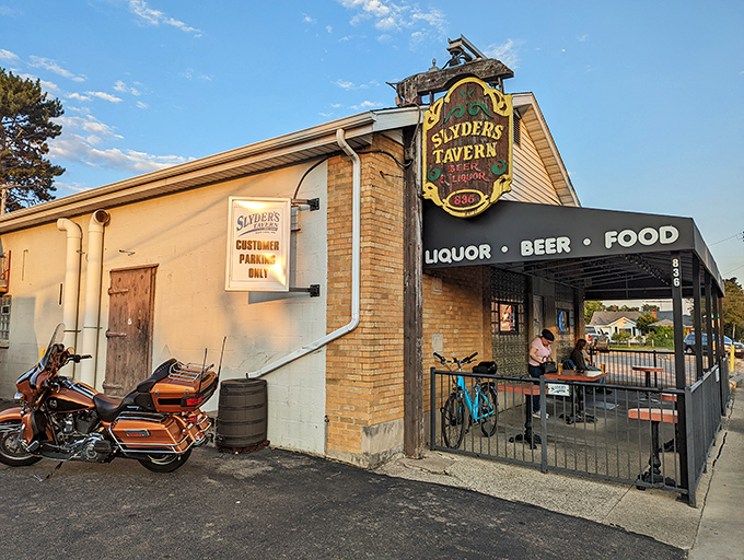 The unassuming exterior of Slyder's Tavern, with its festive string lights, proves once again that the best food often hides behind the most modest facades.