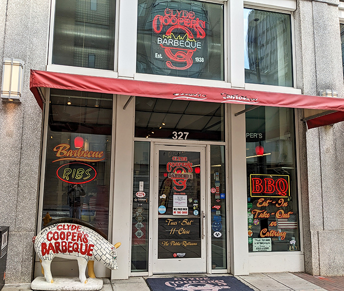 The iconic red awning and pig statue welcome you to Clyde Cooper's &ndash; where barbecue dreams come true since 1938.
