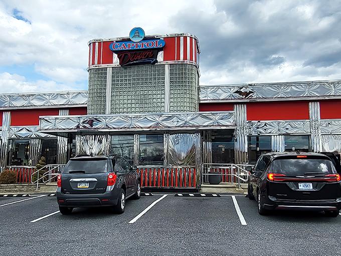 The gleaming red and silver exterior of Capitol Diner stands like a time machine to the 1950s, beckoning hungry travelers with its classic Americana charm.